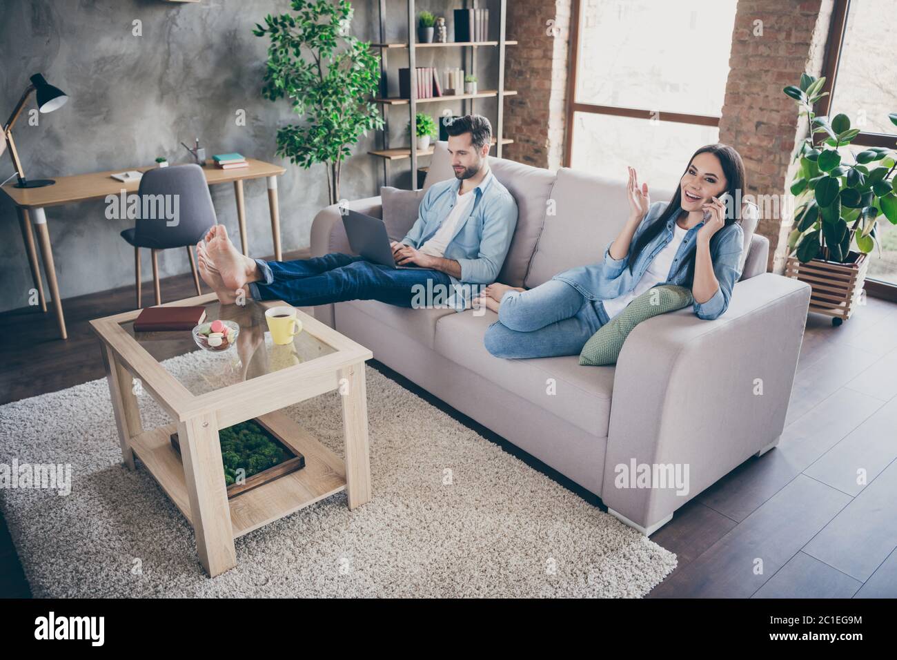 Full length photo of two people man work remote laptop texting typing ...