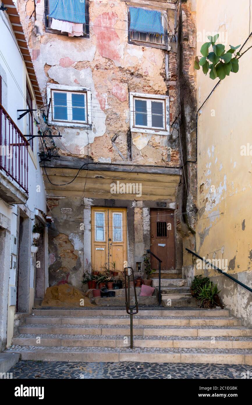 Traditional dilapidated apartment buildings next to renovated buildings ...