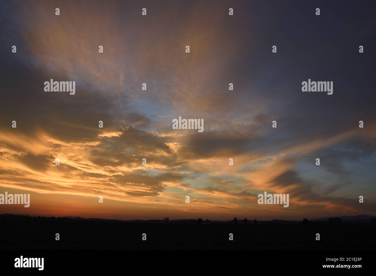 Sunrise with a dramatic sky Stock Photo - Alamy
