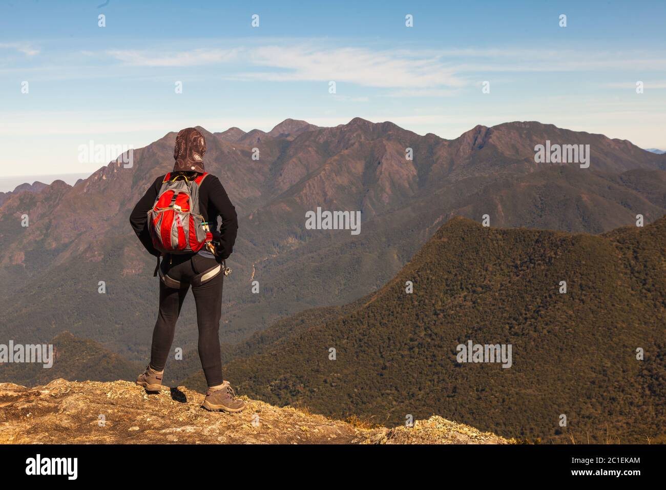 Young girl enjoying view from mountain summit Stock Photo - Alamy