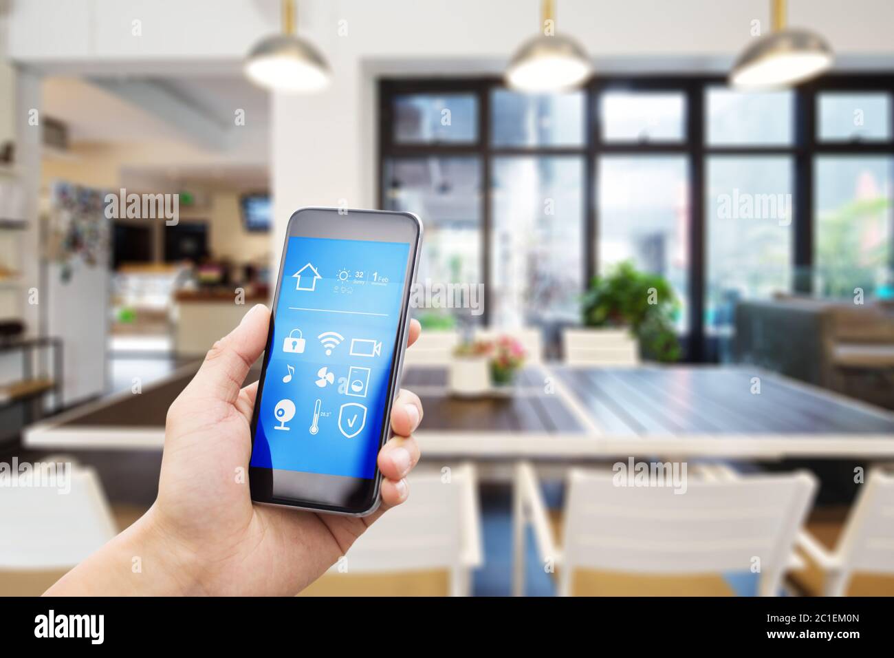 mobile phone with smart home app in modern living room Stock Photo - Alamy