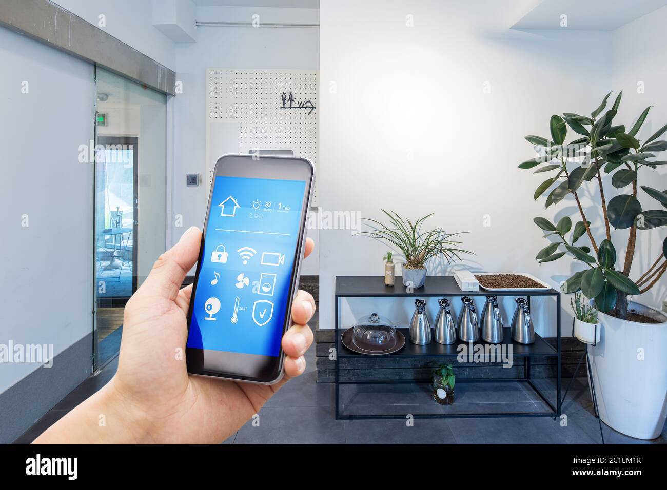 mobile phone with smart home app in modern living room Stock Photo - Alamy