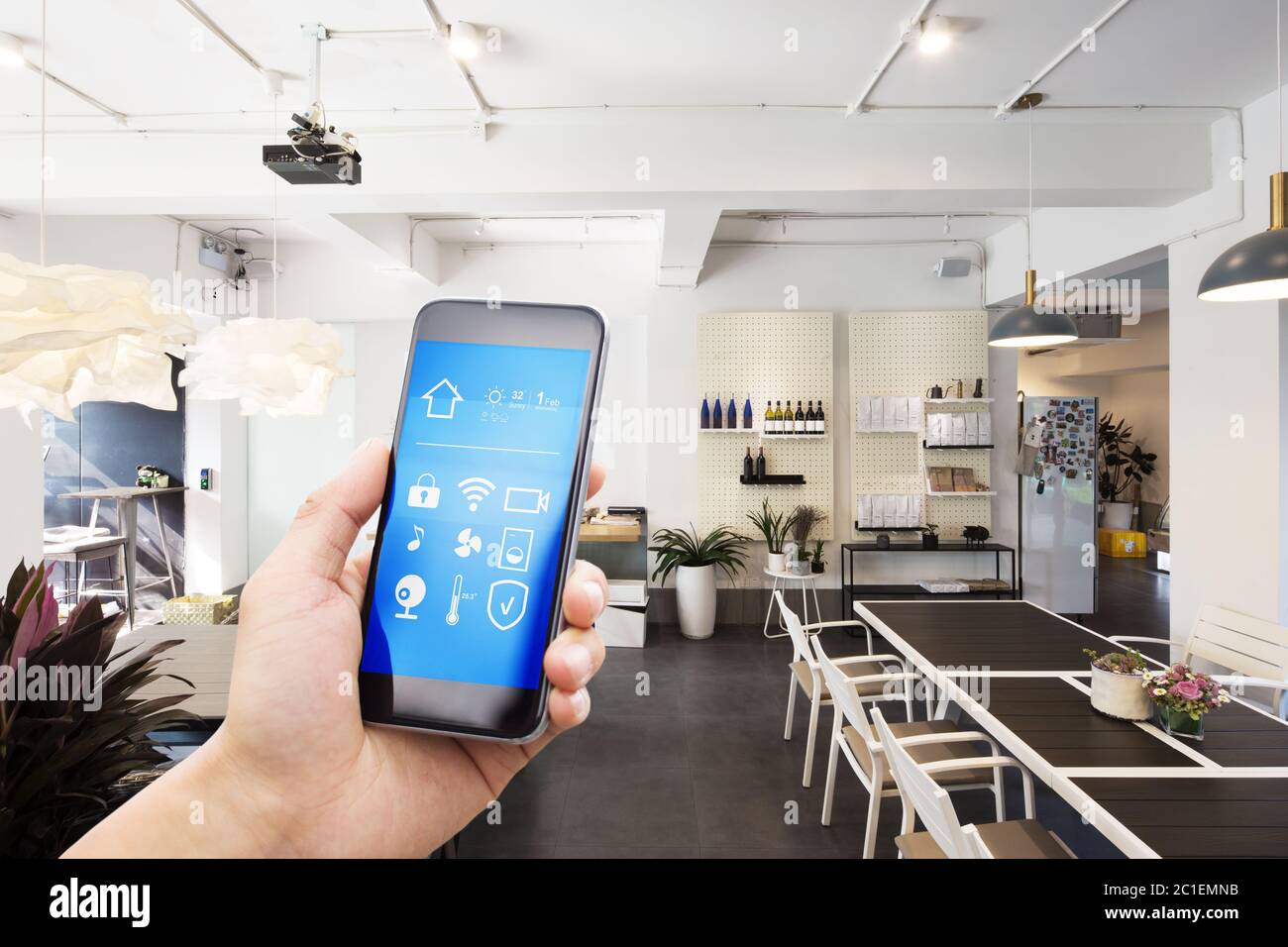 mobile phone with smart home app in modern living room Stock Photo - Alamy