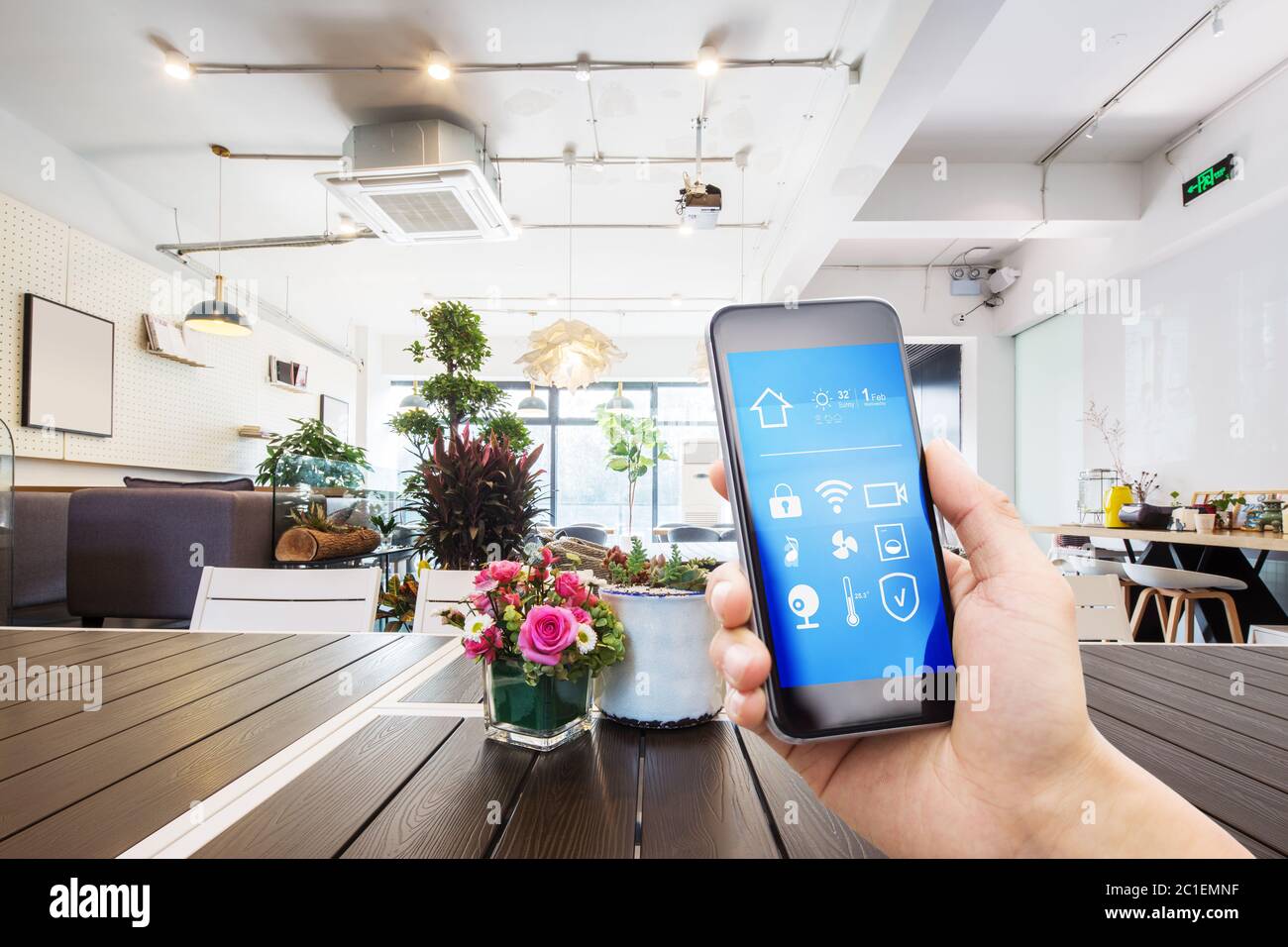 mobile phone with smart home app in modern living room Stock Photo - Alamy