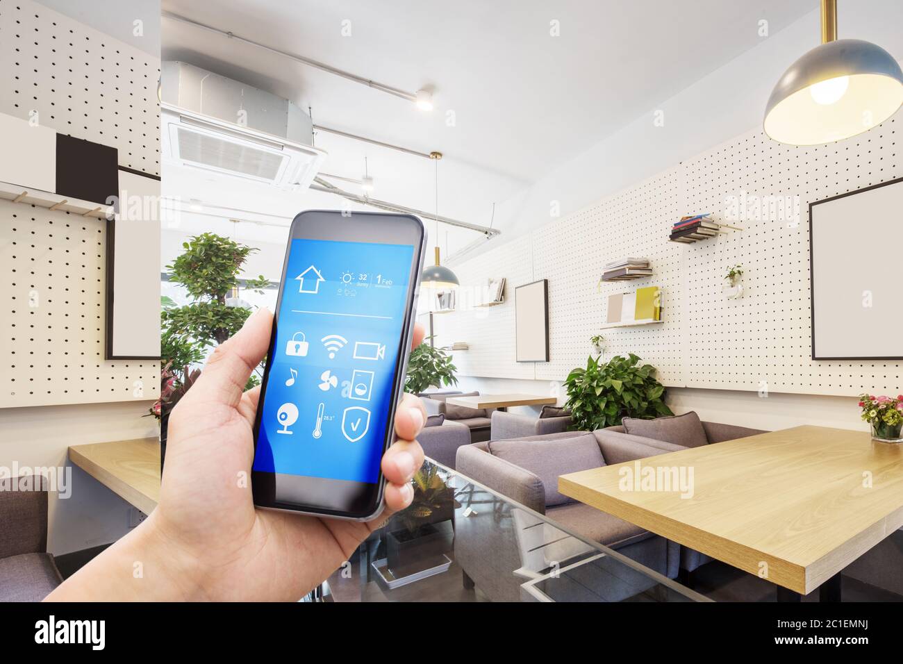 mobile phone with smart home app in modern living room Stock Photo - Alamy