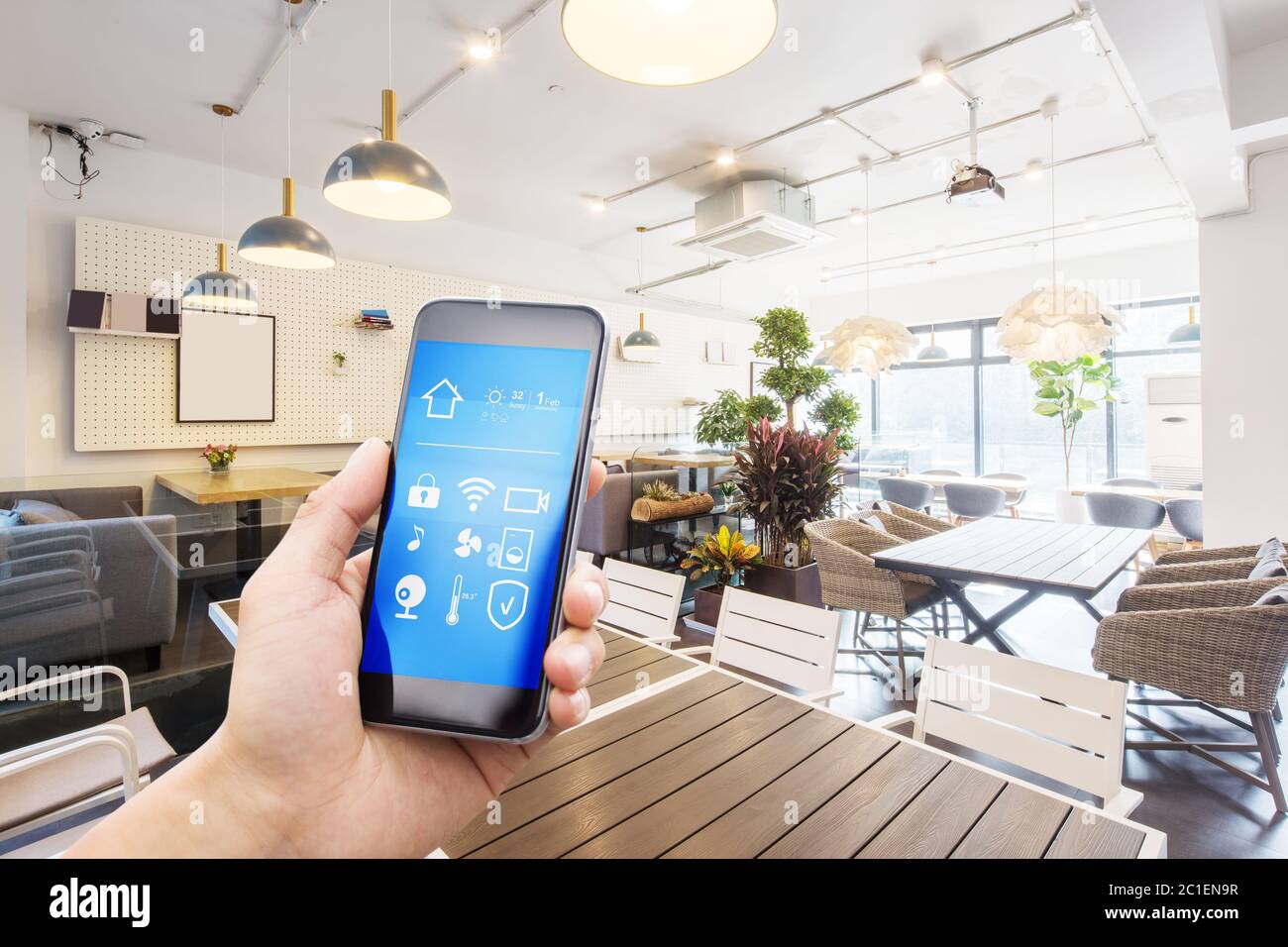 mobile phone with smart home app in modern living room Stock Photo - Alamy