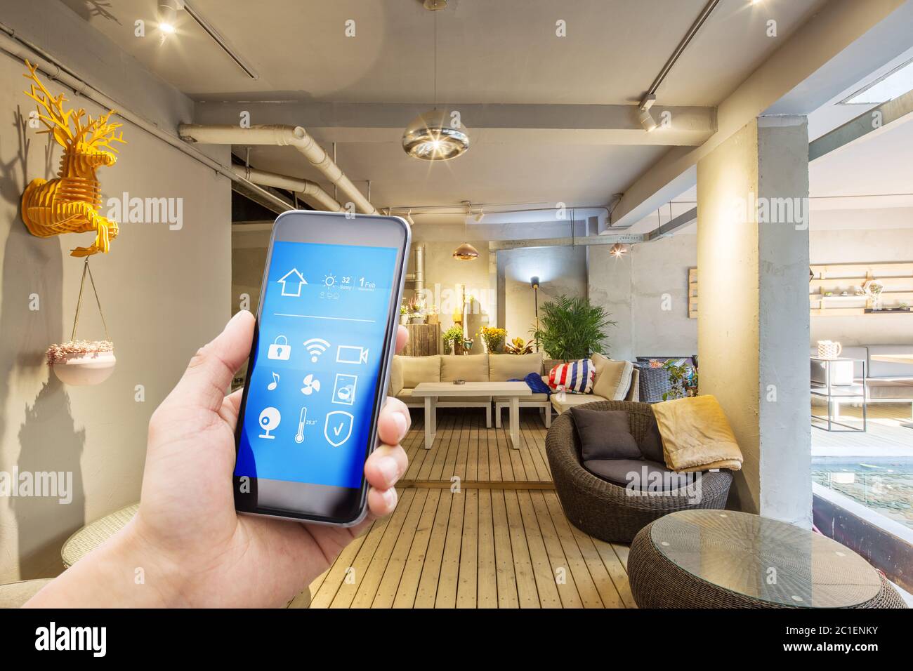 mobile phone with smart home app in modern living room Stock Photo - Alamy
