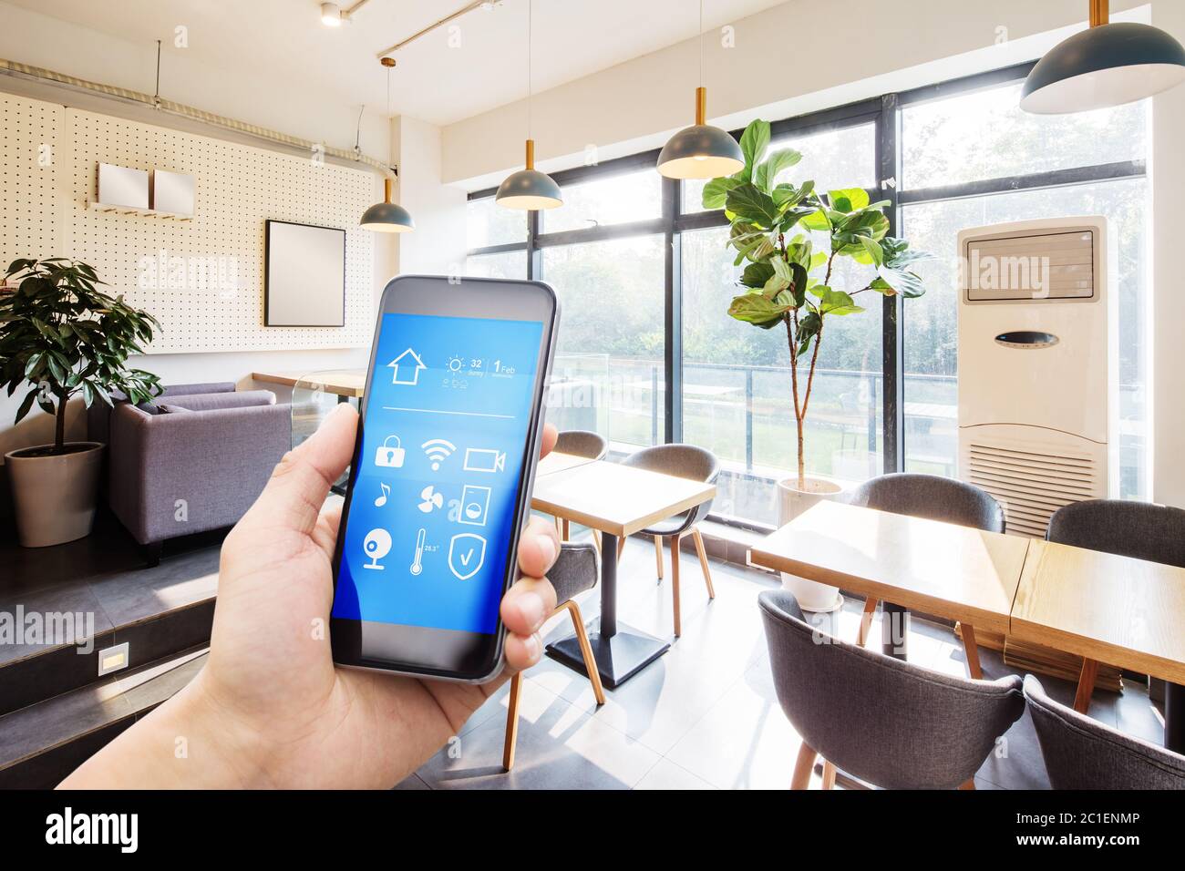 mobile phone with smart home app in modern living room Stock Photo - Alamy