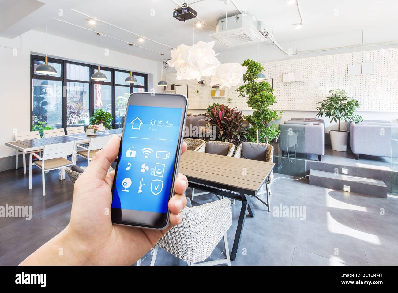 mobile phone with smart home app in modern living room Stock Photo - Alamy
