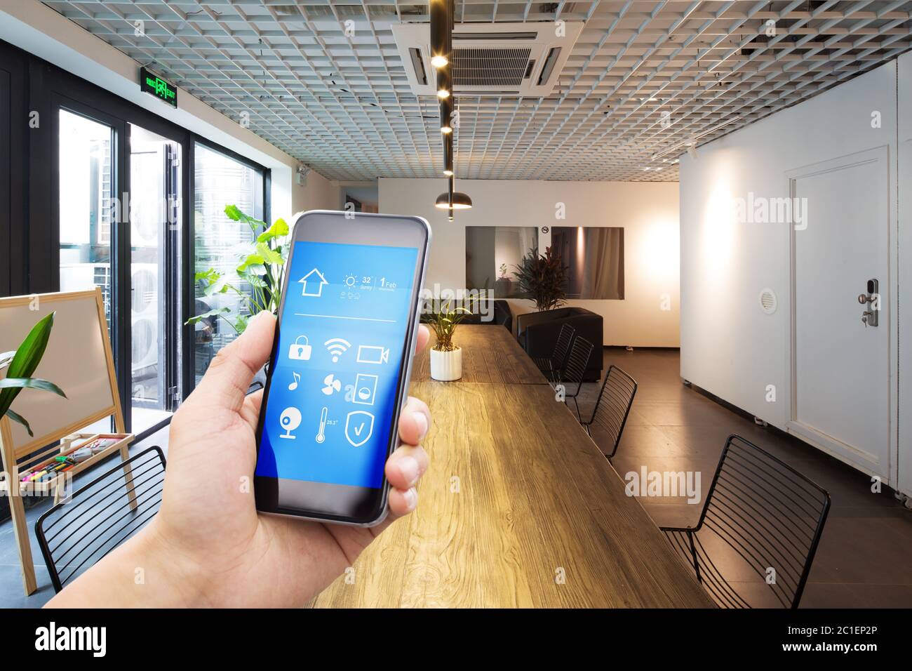 mobile phone with smart home app in modern living room Stock Photo - Alamy