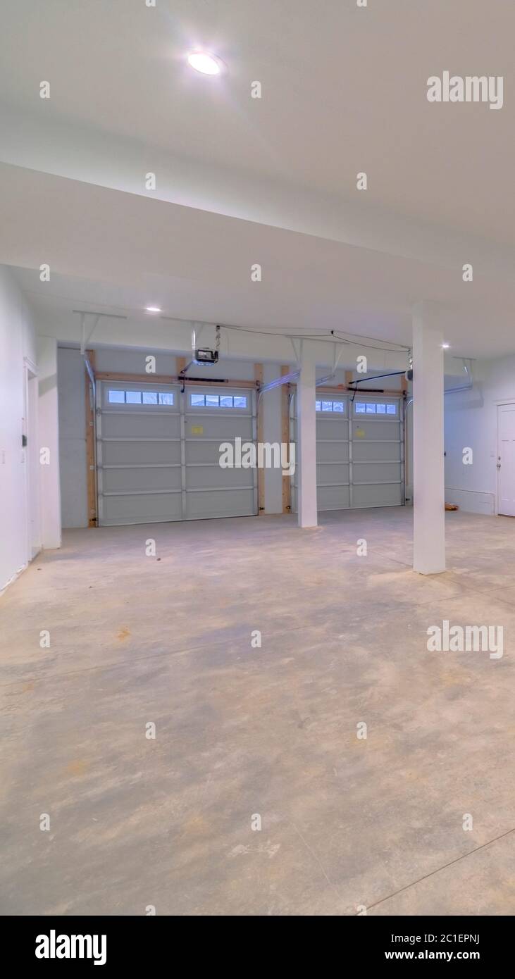 Vertical Large white clean empty garage for cars Stock Photo - Alamy