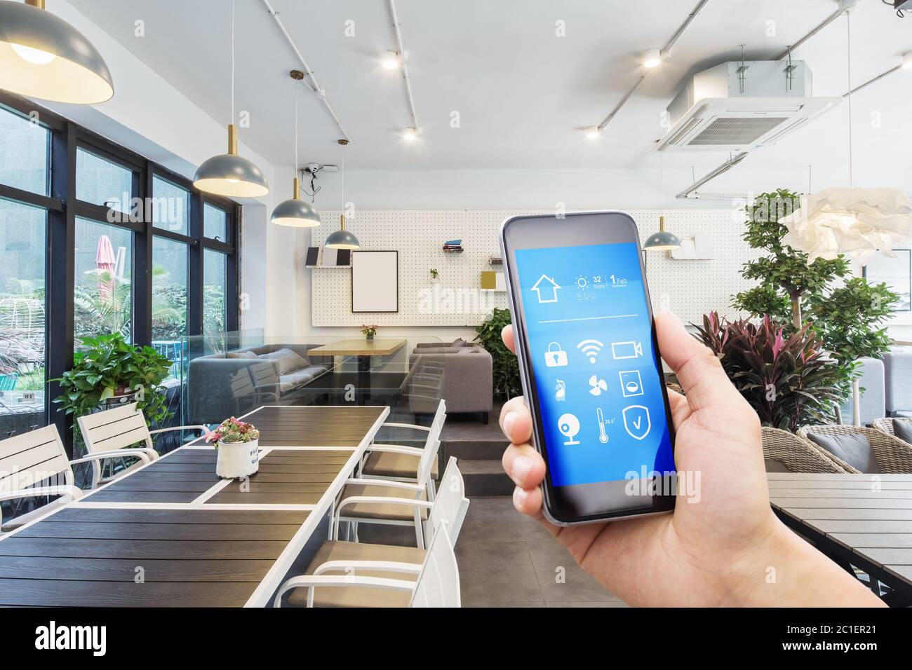 mobile phone with smart home app in modern living room Stock Photo - Alamy