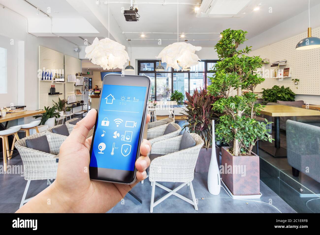 mobile phone with smart home app in modern living room Stock Photo - Alamy