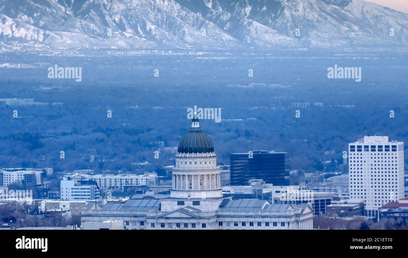 Panorama Utah State Capital Building against steep snowy mountain and ...