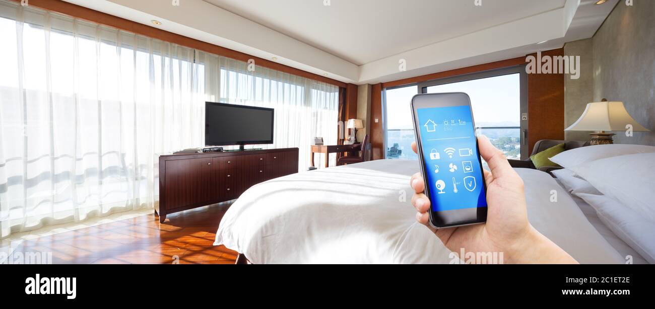 mobile phone with smart home app in modern bed room Stock Photo - Alamy