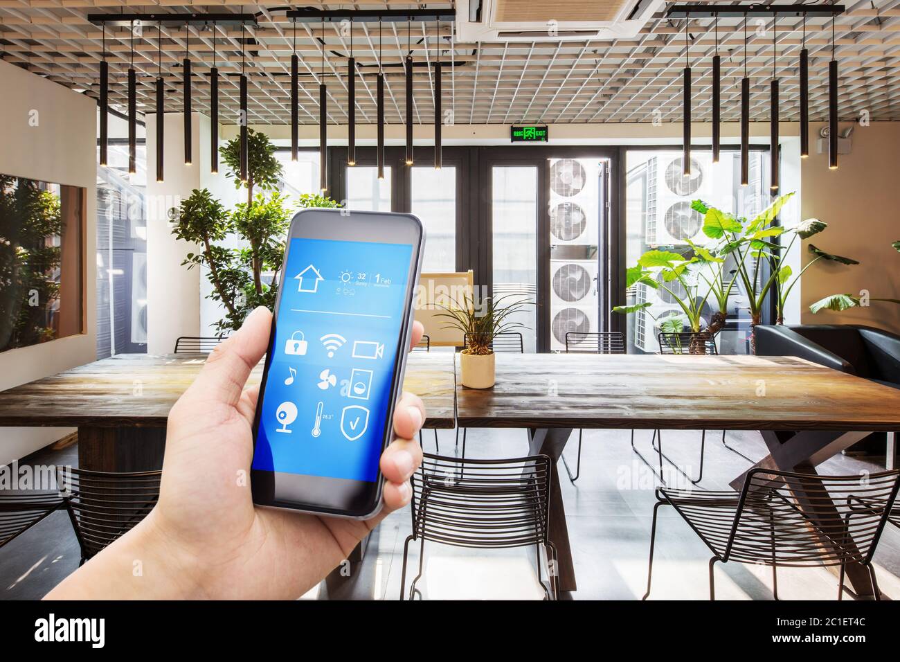 mobile phone with smart home app in modern living room Stock Photo - Alamy