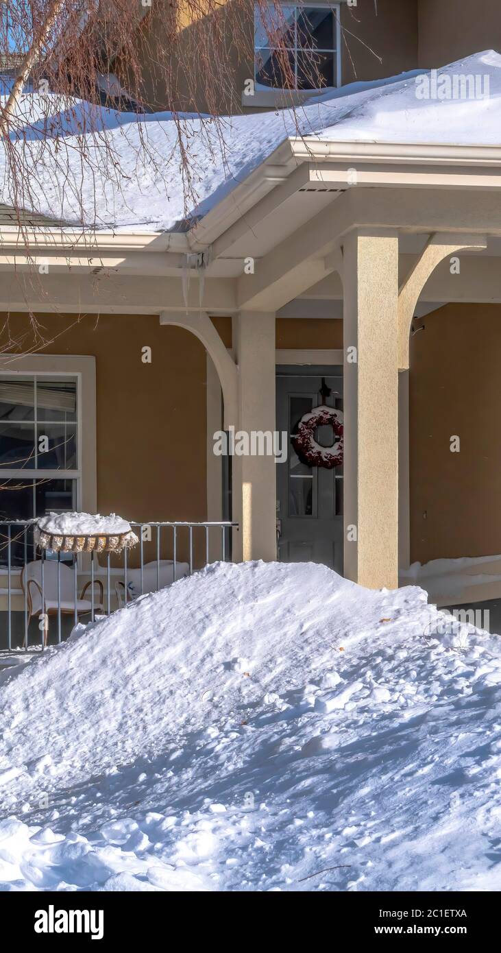 Vertical crop Home on mountainside residential community with porch and ...