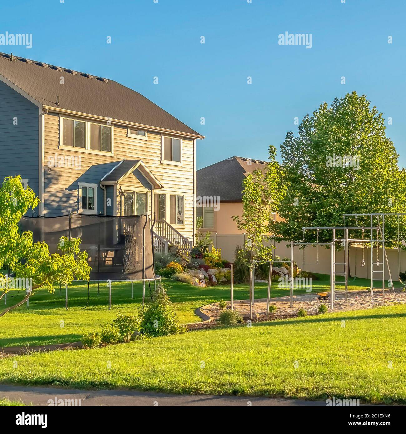 Square Pathway amid grassy terrain in front of neighborhood homes under ...