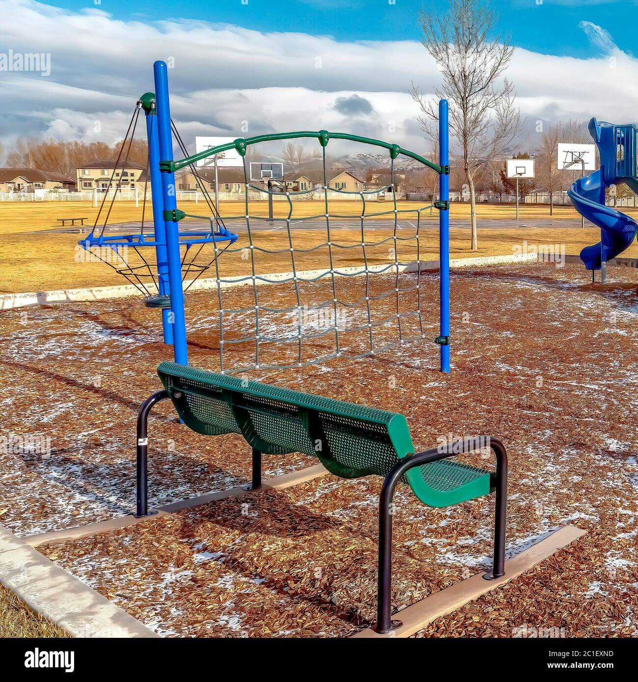 Square frame Playground and benches on a park with view of homes and ...