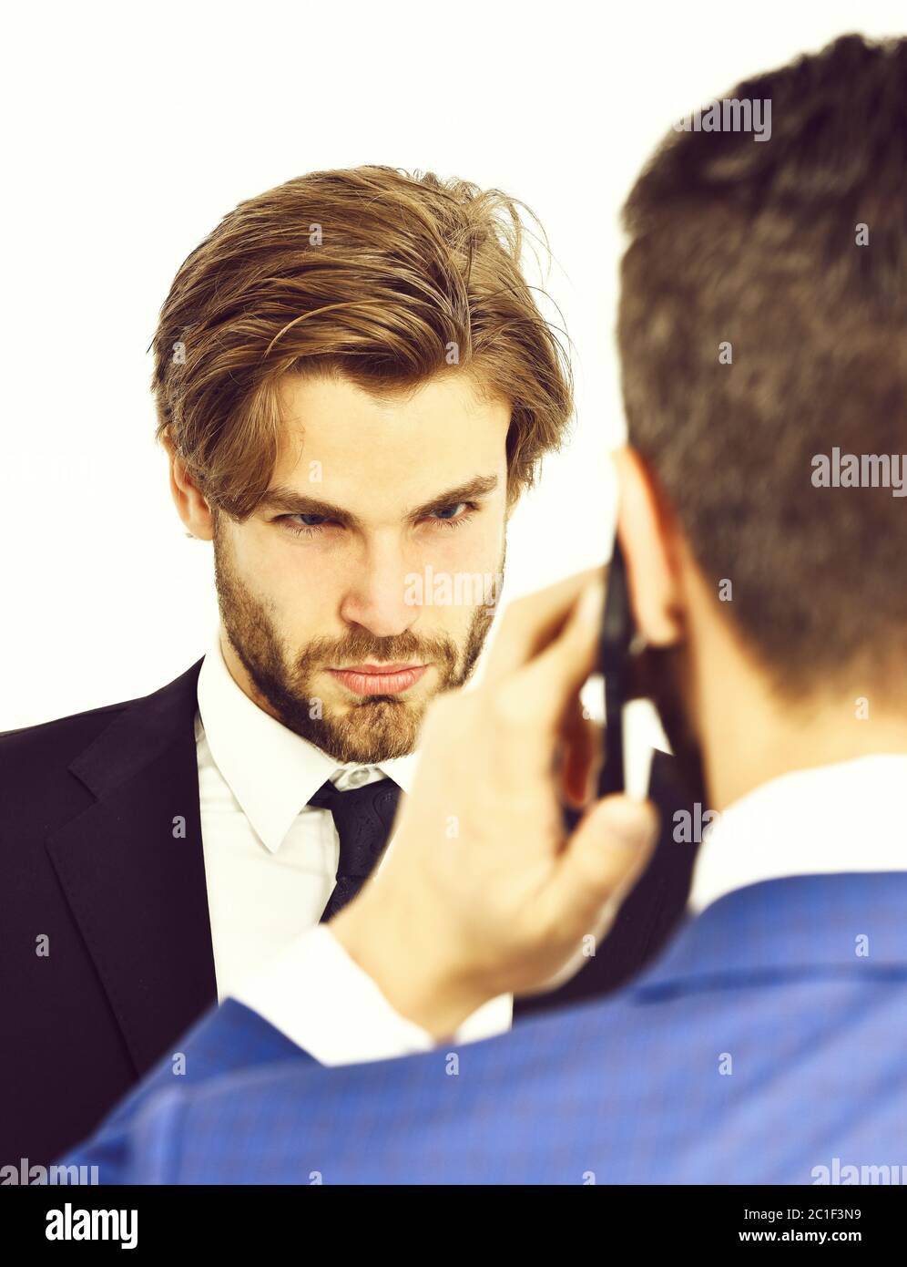 man with angry serious face or businessmen speaking on mobile or cell ...