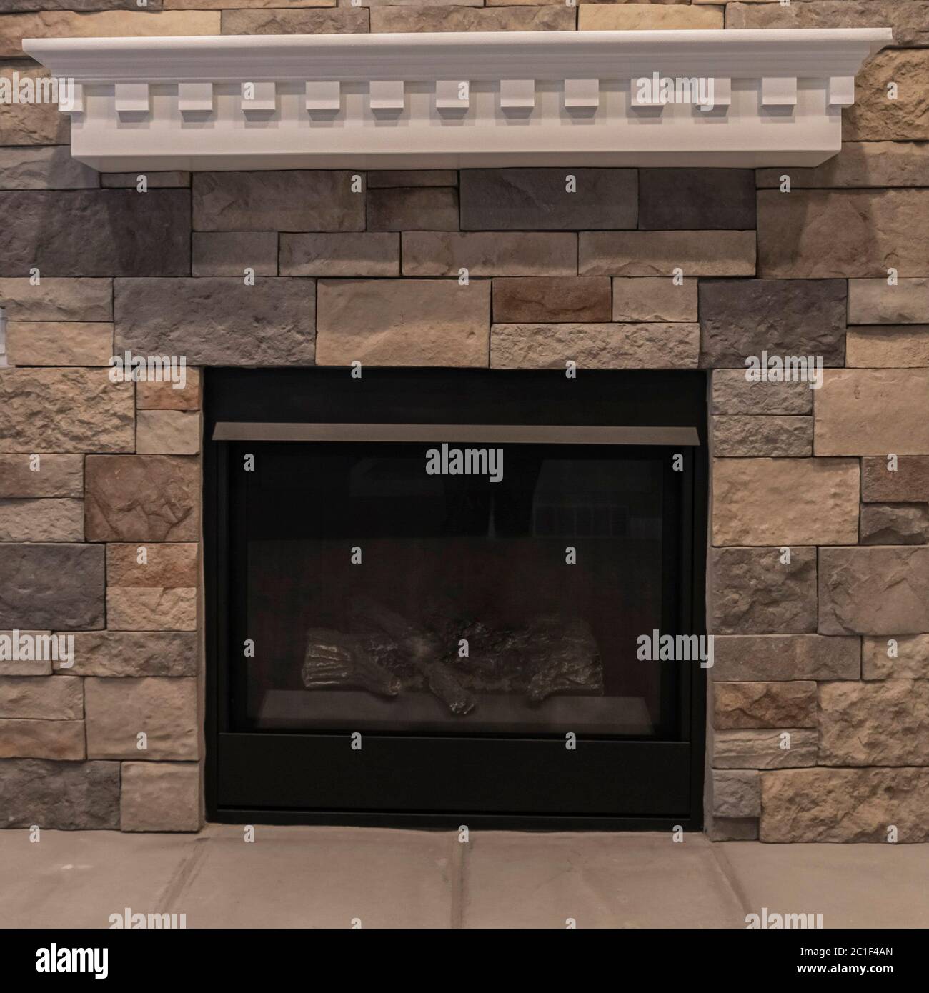 Square Fire insert in a feature stone brick wall Stock Photo - Alamy