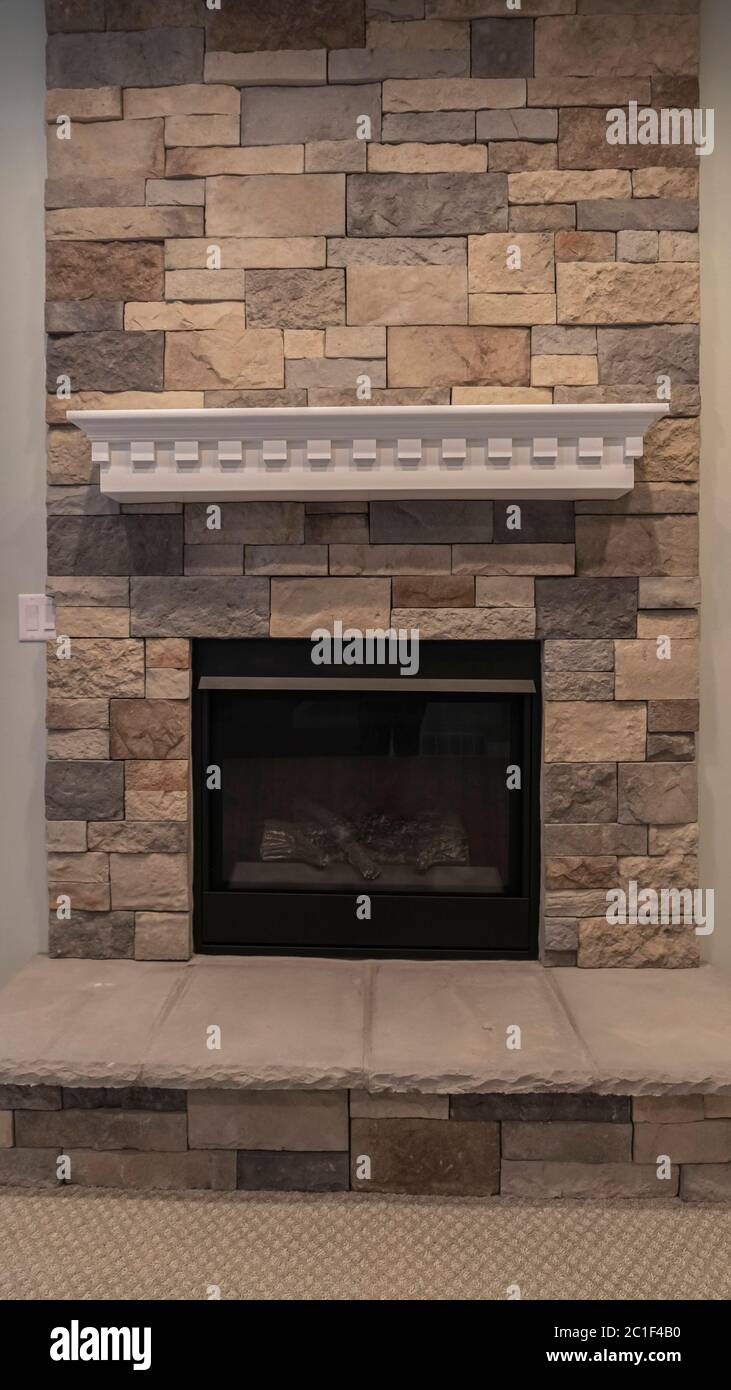 Vertical Fire insert in a feature stone brick wall Stock Photo - Alamy
