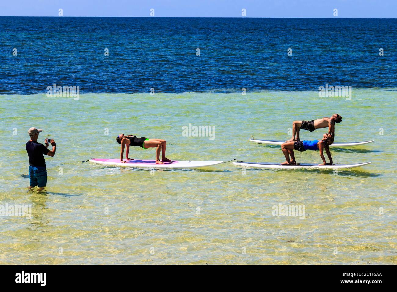 Yoga on a stand up paddle board, taught at Bahia Honda State Park along ...