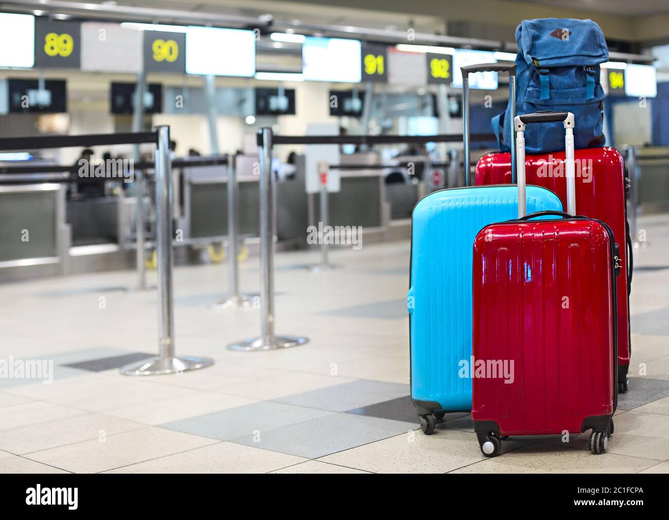 Stack of travelers luggage in airport terminal Stock Photo - Alamy