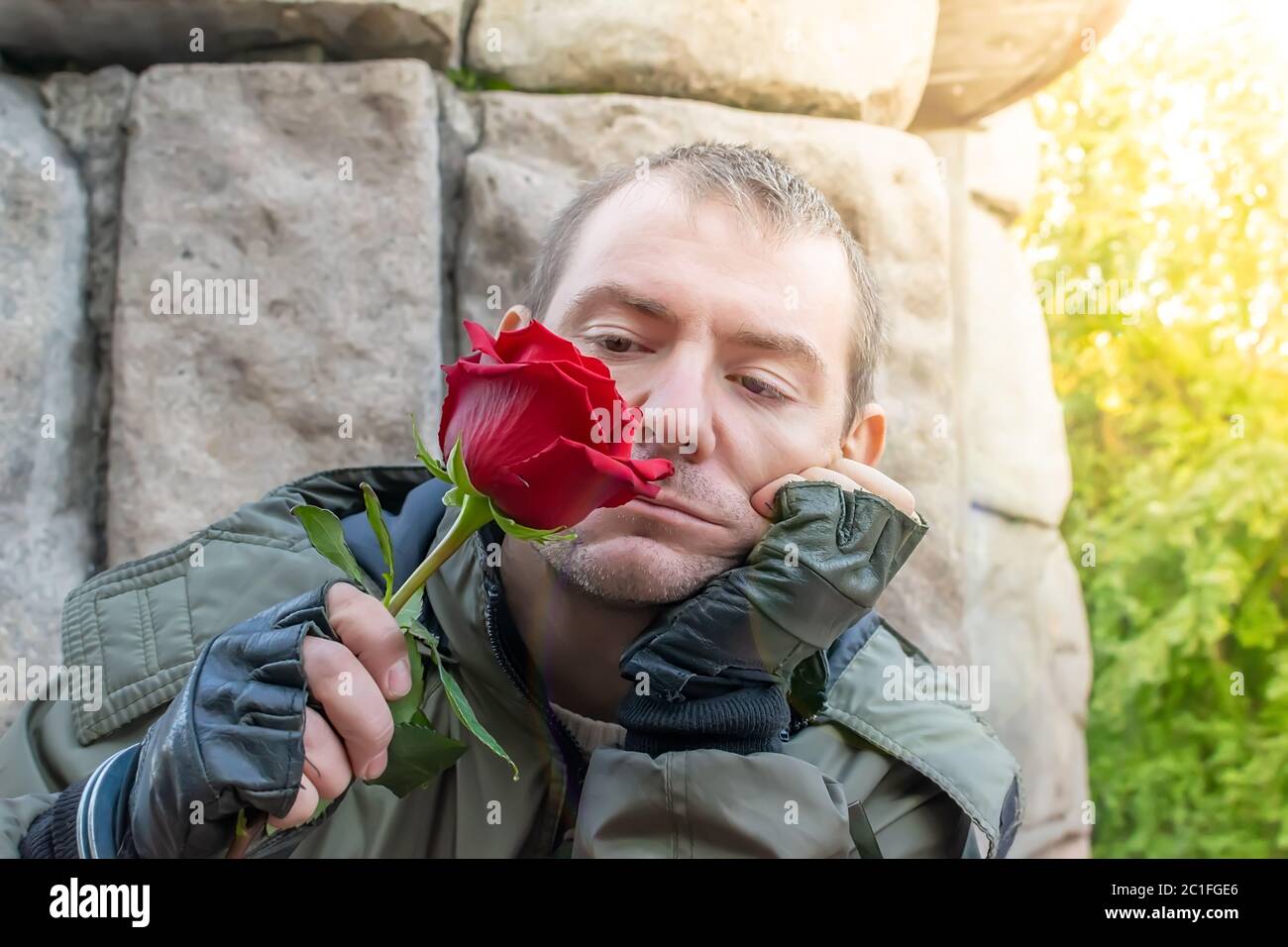 Man sniffing a flower hi-res stock photography and images - Alamy