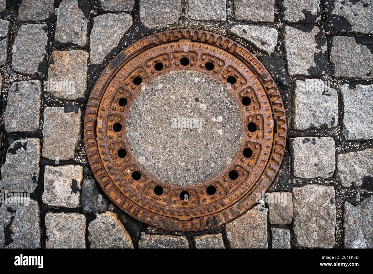 Manhole on the street leading to the sewers Stock Photo - Alamy