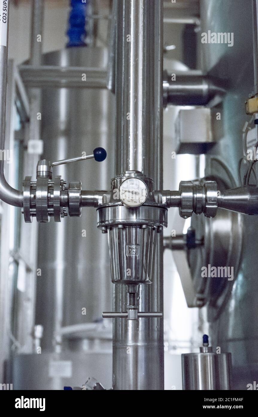 Industrial pressure meter - barometer and water pipes in the background ...