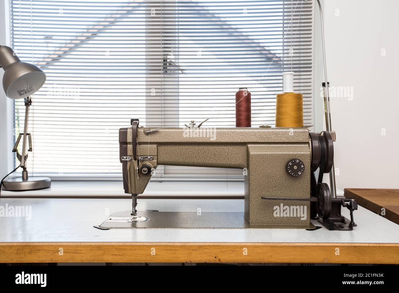 tailor workshop with white sewing machine, fashion dummy, details and ...
