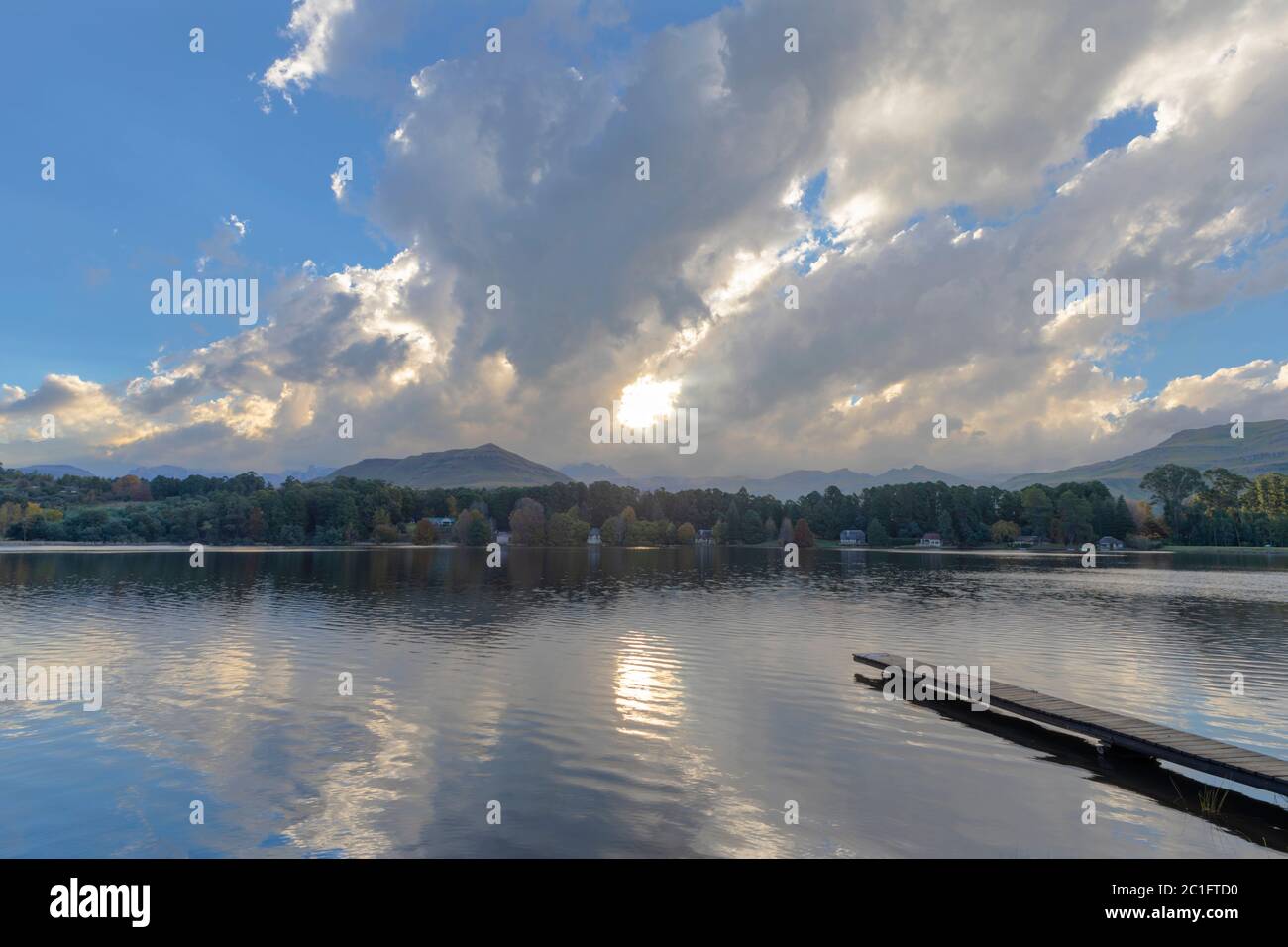 Sun break through clouds before sunset Stock Photo - Alamy