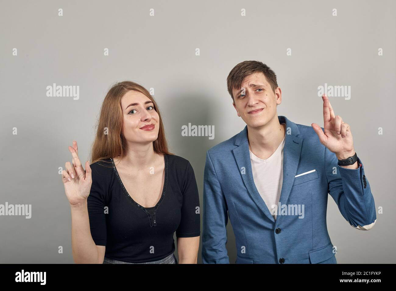 Crosses fingers, prays before important occasion, wishes luck, hopes in ...