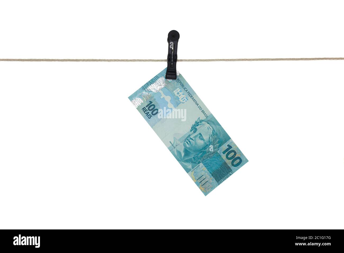 Brazilian 100 Real bank note in a clothesline - Money laundering ...