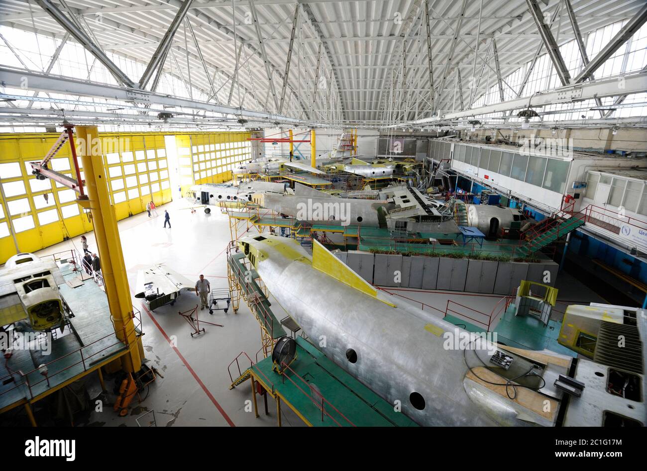 Maintenance hall with planes standing in aircraft fixtures for repair ...