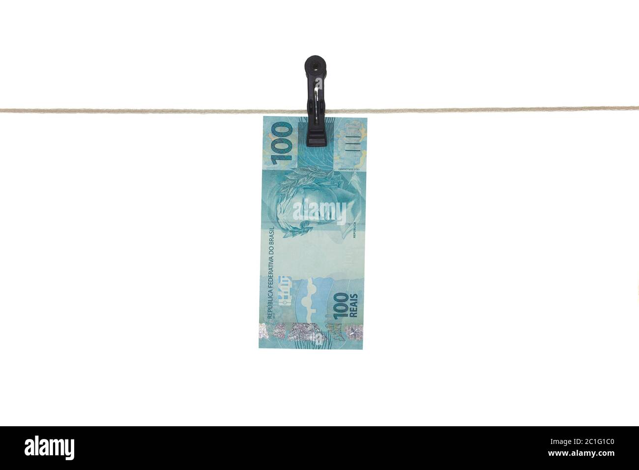Brazilian 100 Real bank note in a clothesline - Money laundering ...