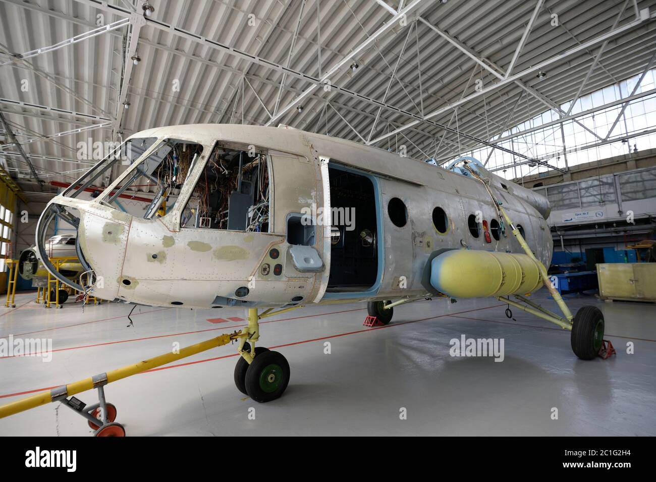 At the maintenance hall. Helicopter plane standing in aircraft fixture ...