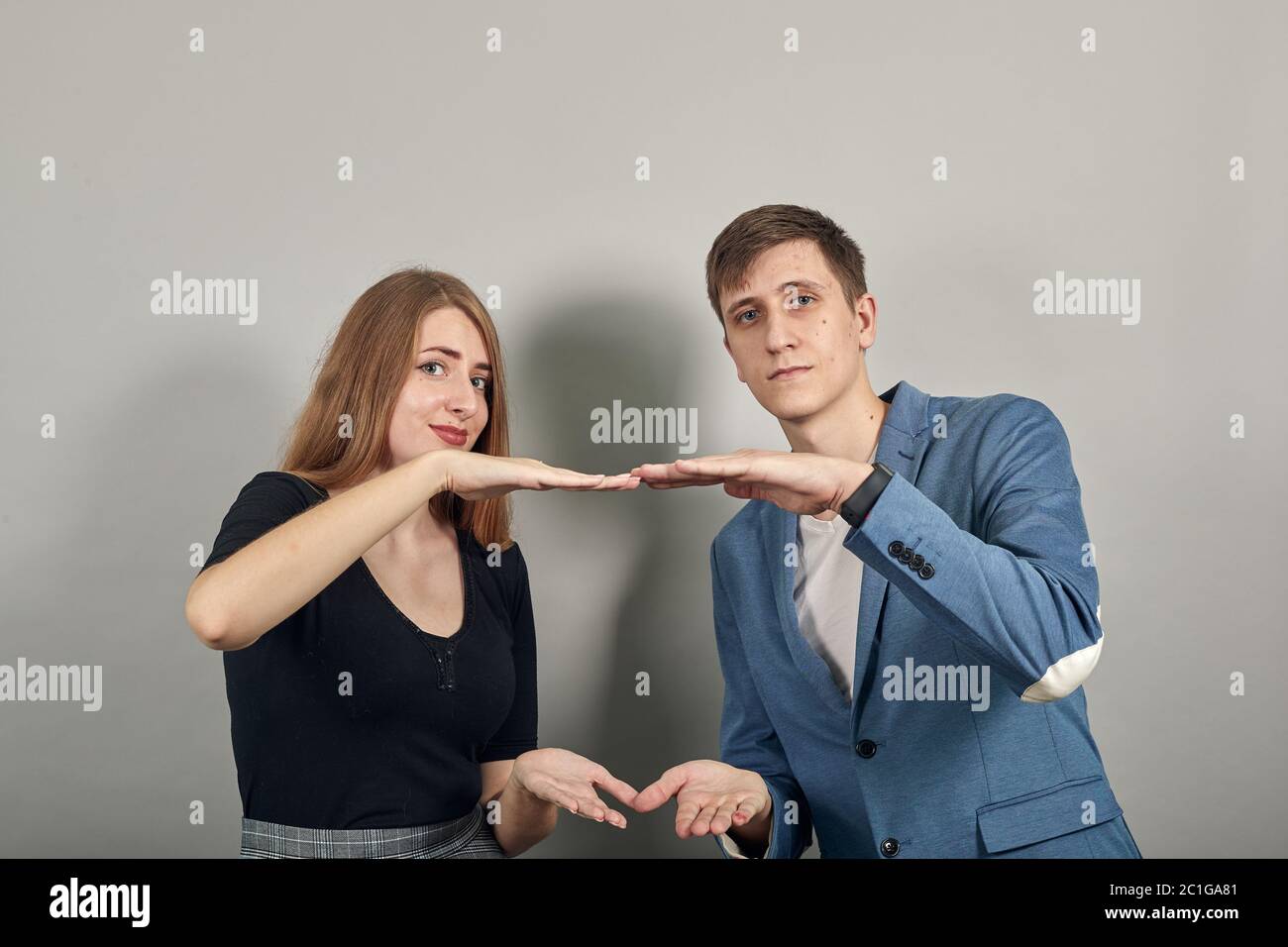 Shapes big object with two hands, gasps from surprise, holding palms in ...