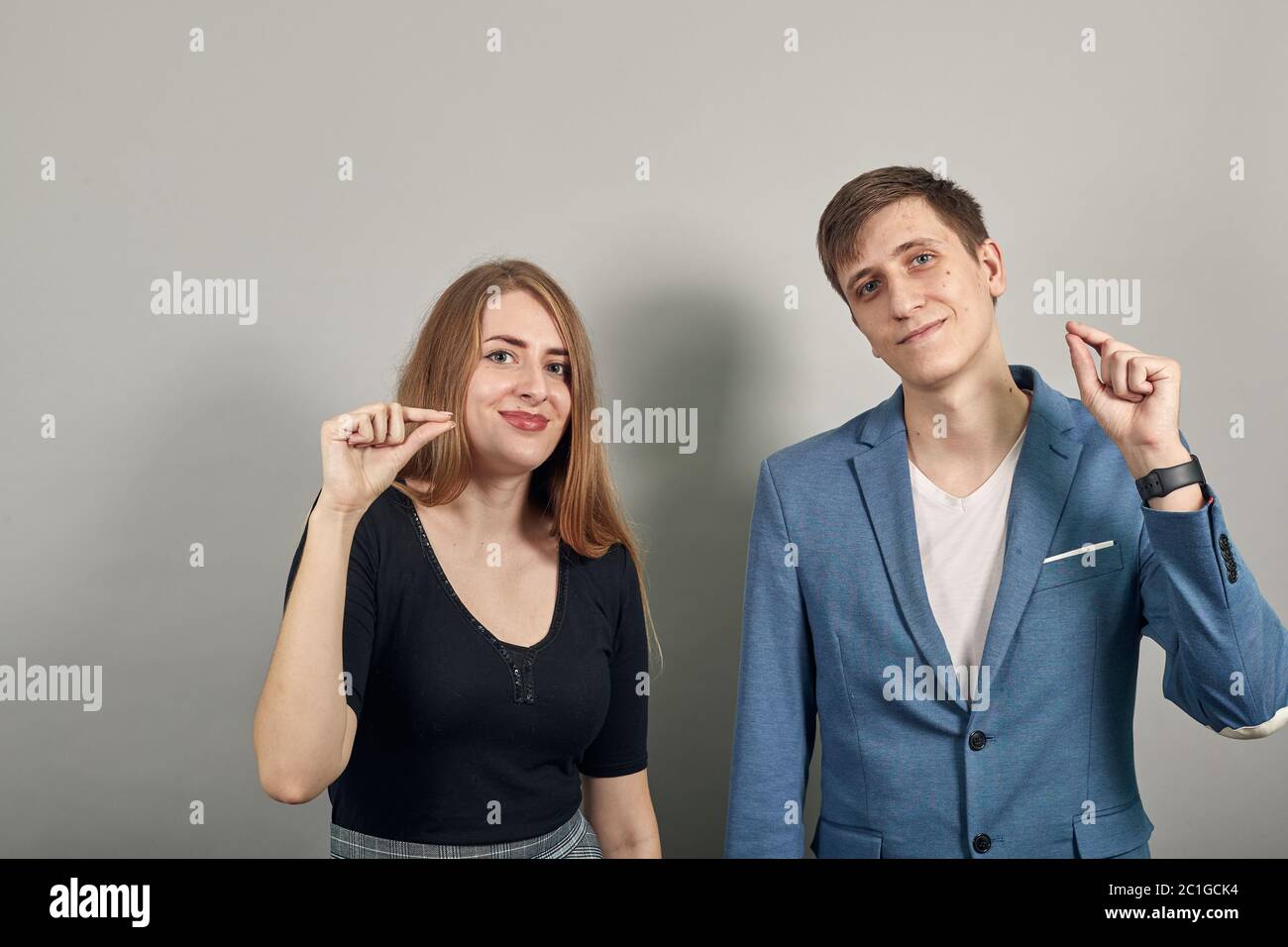 Shapes little object two fingers, gasps from surprise, holding palms in ...