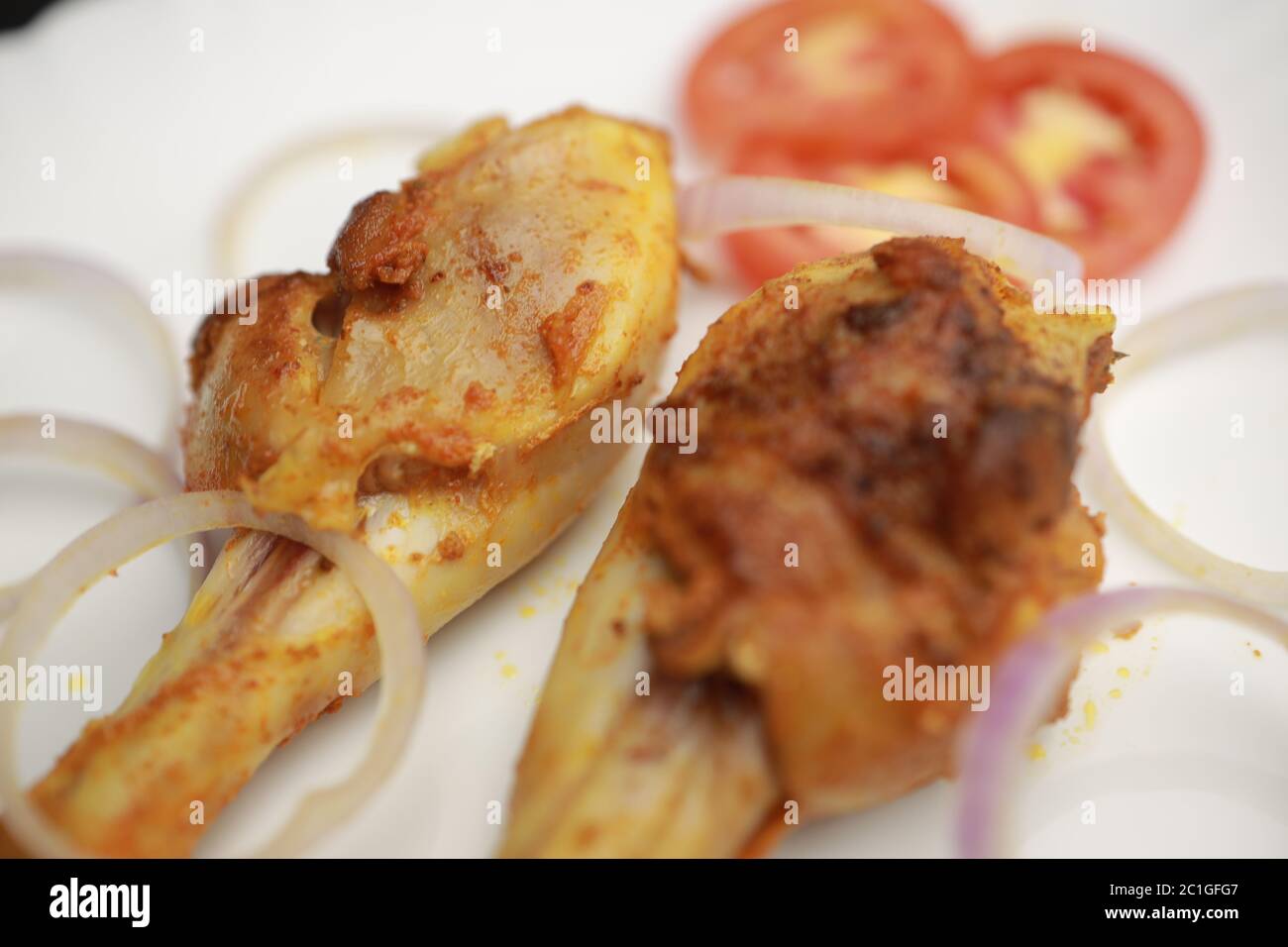 Delicious fried chicken leg served in white plate with vegetable salad ...