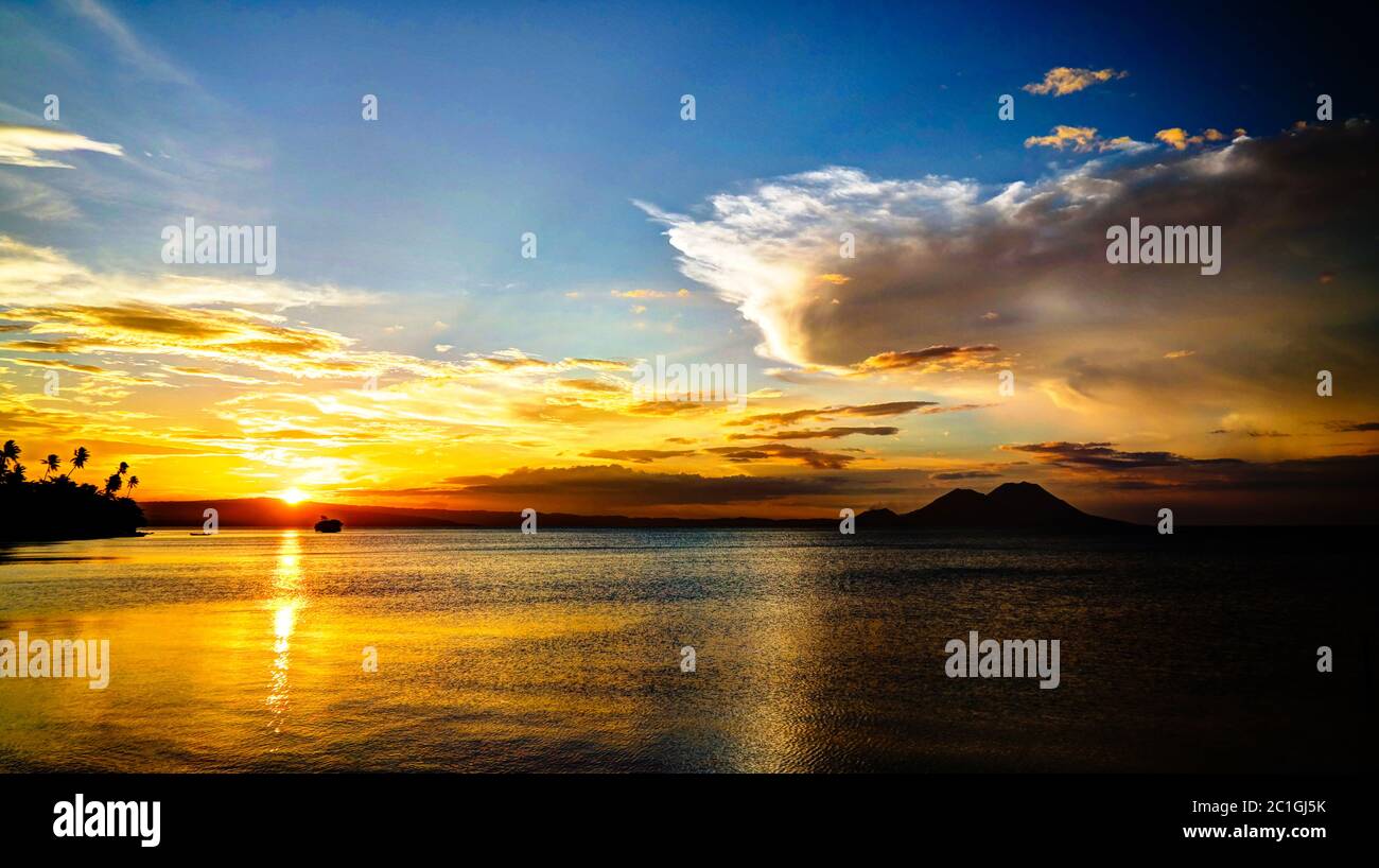 Sunset panorama with Tavurvur volcano at Rabaul, New Britain island ...