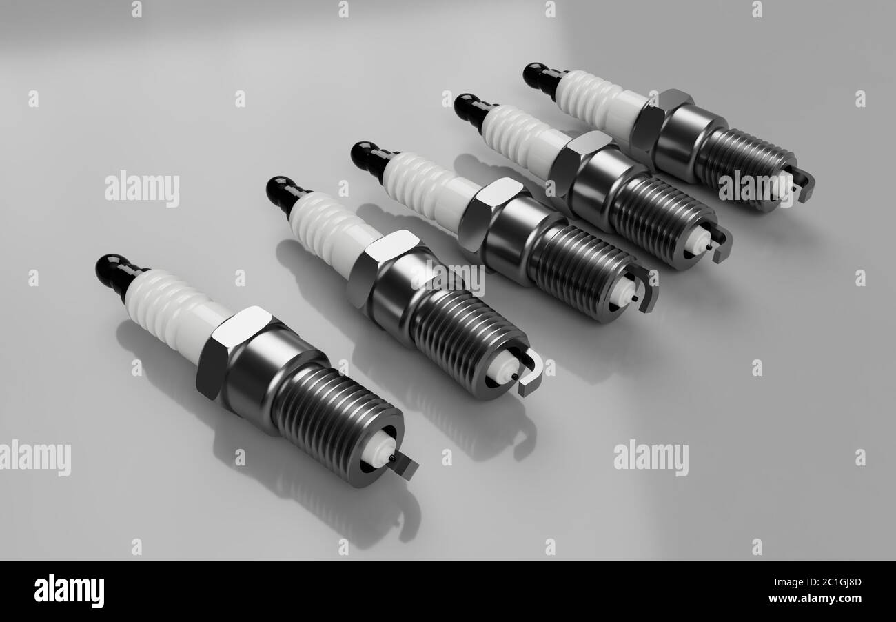 Several spark plugs on the grey background Stock Photo - Alamy