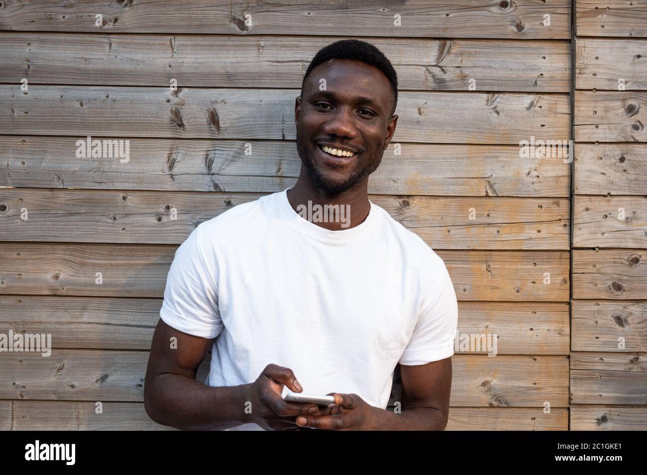 Handsome black man smiling toothy smile looking at camera. Medium shot ...