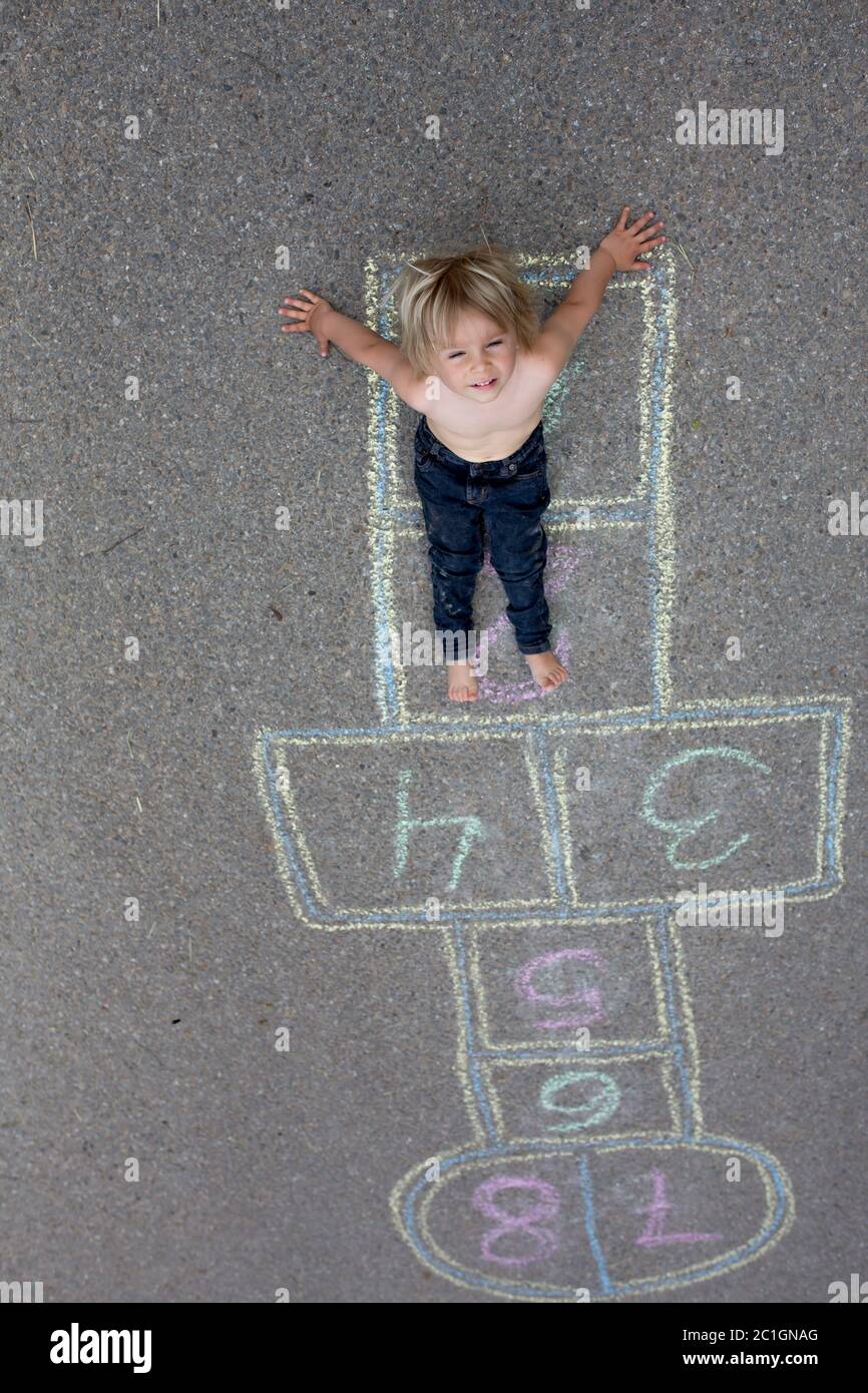 Boy Playing Hopscotch Outside On High Resolution Stock Photography and ...