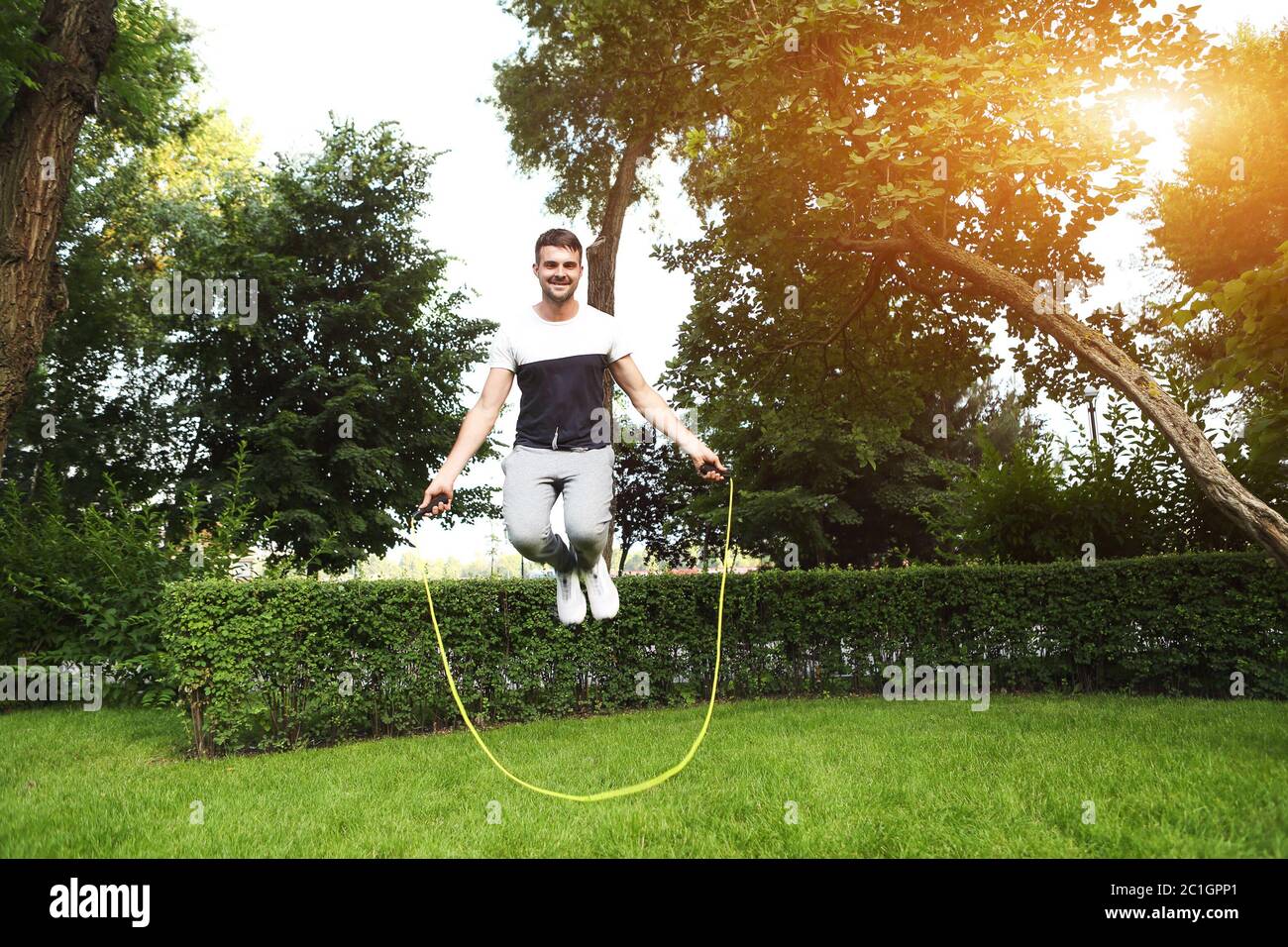 Young sporty man with jumping rope Stock Photo - Alamy