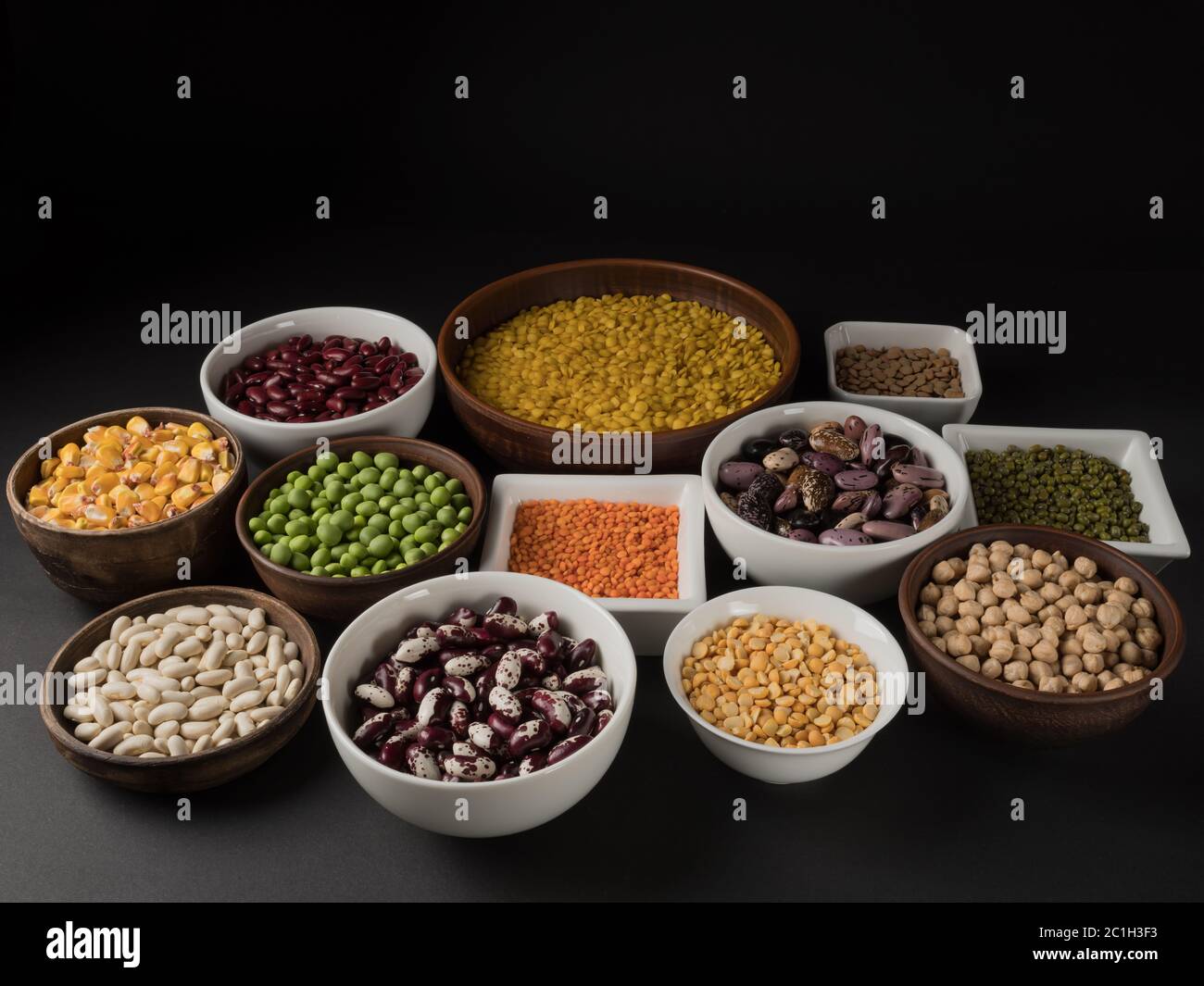 Organic legumes. Black background. Different varieties of peas, beans ...