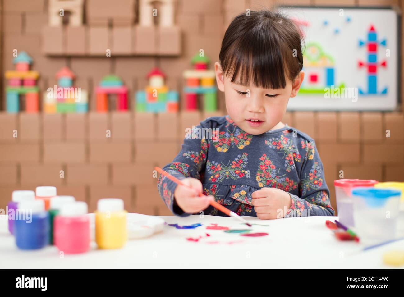 toddler girl practice color painting at home Stock Photo - Alamy