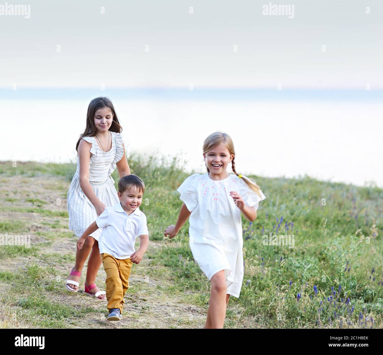 Kids playing and running in the park Stock Photo - Alamy