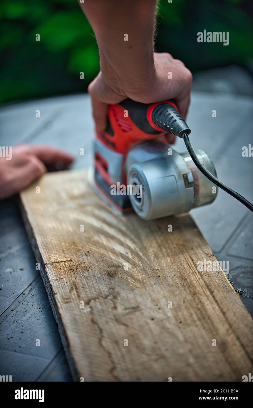 Hand wooden board is processed with a grinding machine Stock Photo - Alamy